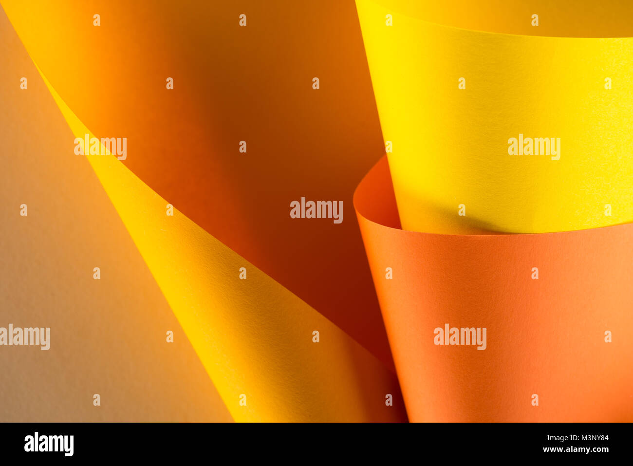 close-up shot of rolled orange and yellow papers for background Stock ...