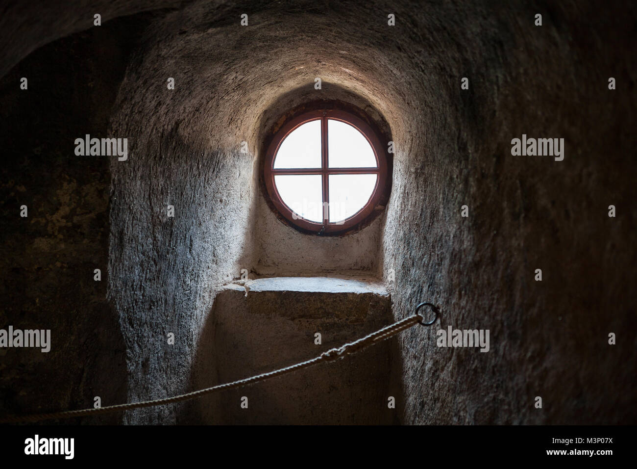 The old round window on the ancient wall of the fortress tower, Europe ...