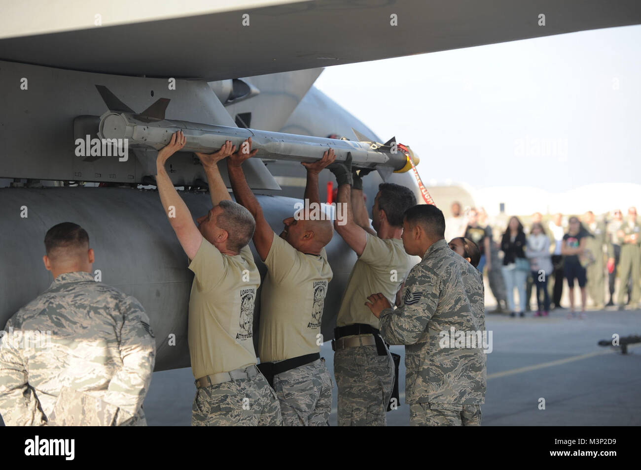 Air Force leaders load weapons onto an F-15 Eagle during a weapons ...