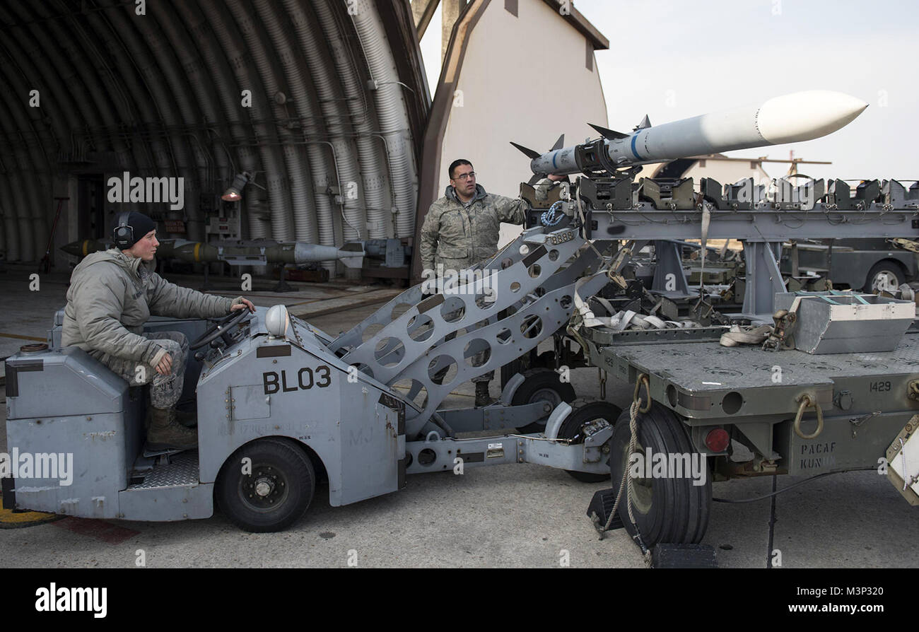 U.S. Airmen prepare to load an F-16 Fighting Falcon aboard Kunsan Air ...