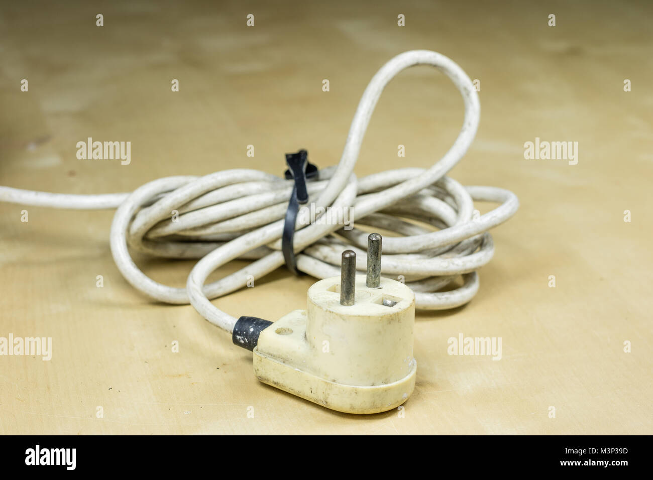 Electric cables, plugs and connectors on a wooden workshop table ...