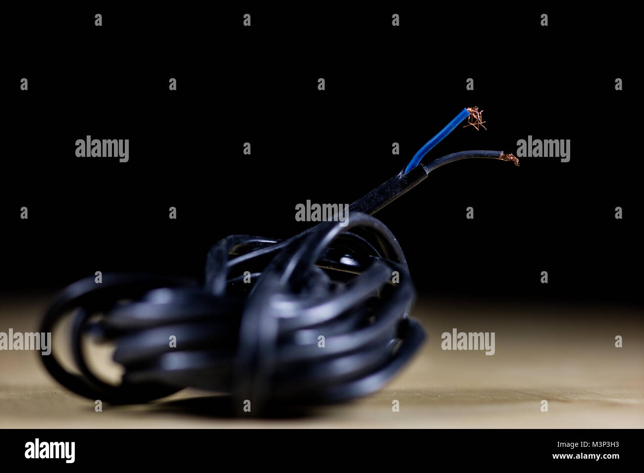 Electric cables, plugs and connectors on a wooden workshop table ...