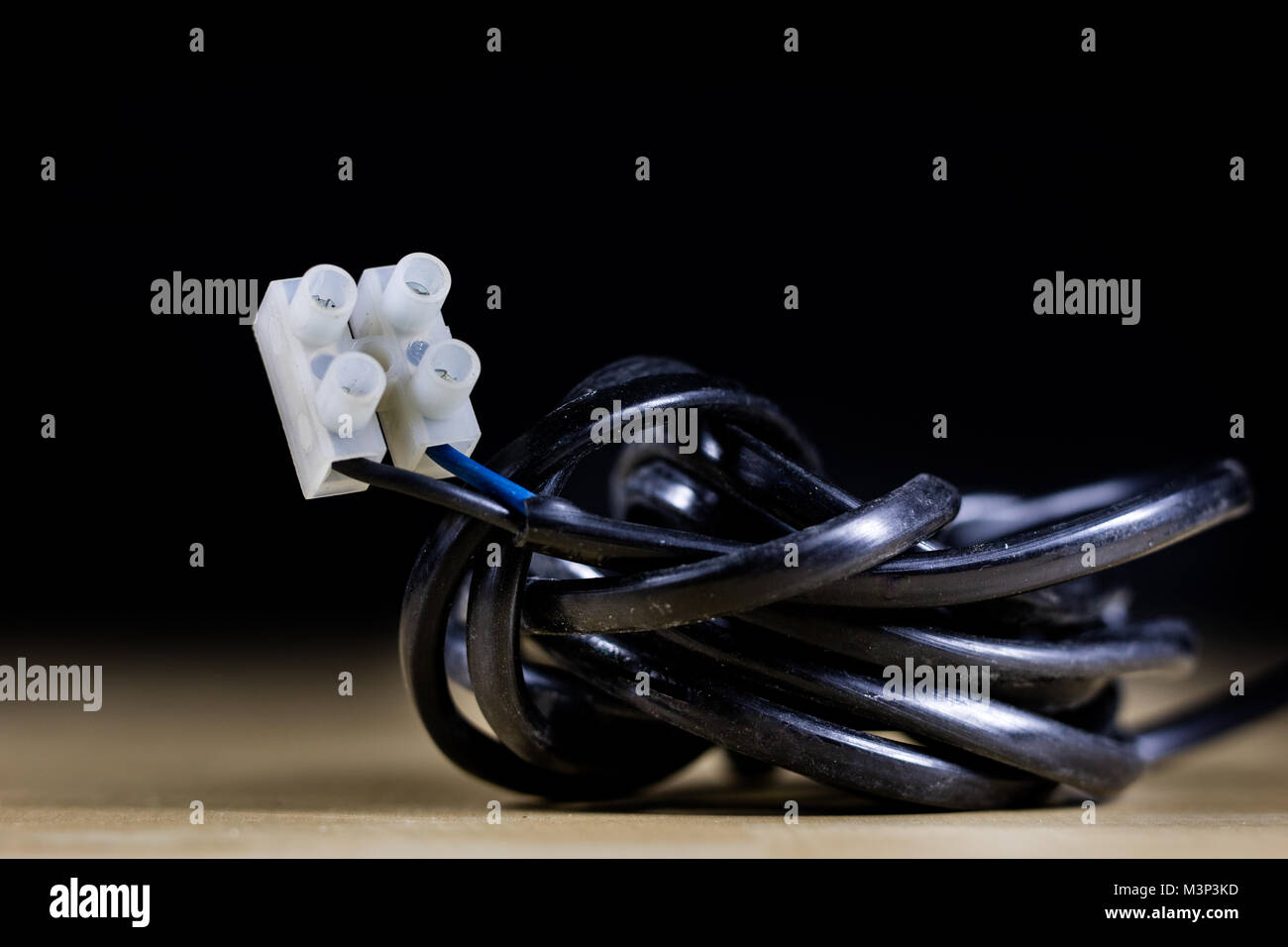 Electric cables, plugs and connectors on a wooden workshop table ...