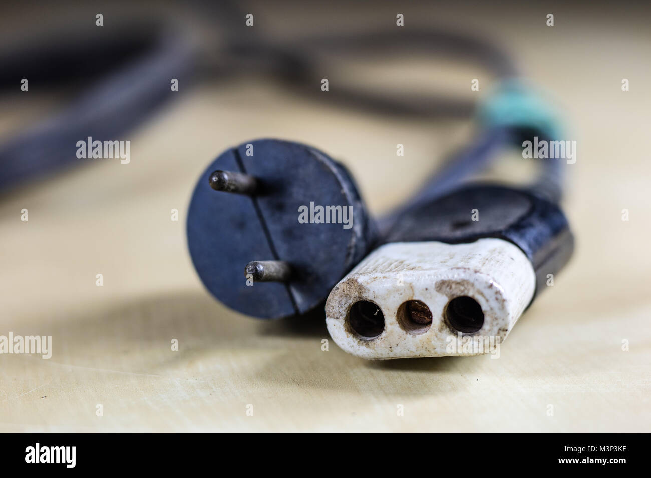 Electric cables, plugs and connectors on a wooden workshop table ...