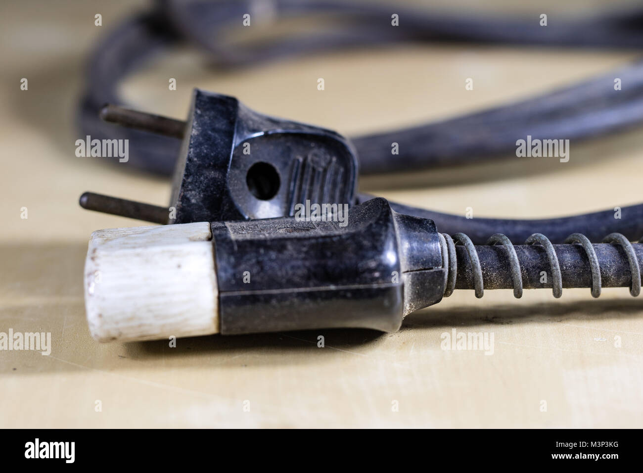 Electric cables, plugs and connectors on a wooden workshop table ...