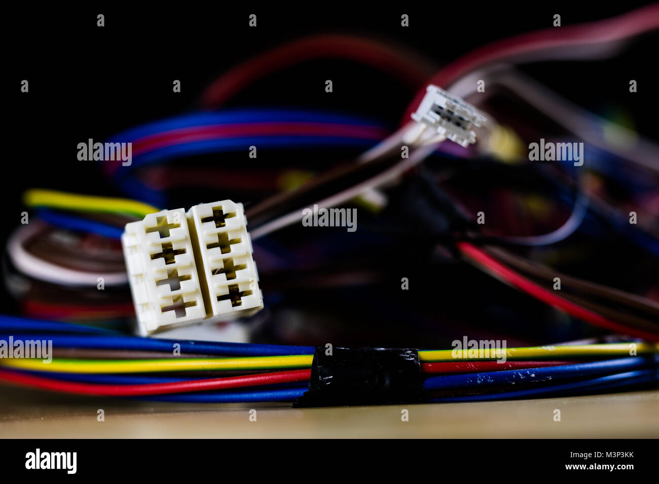 Electric cables, plugs and connectors on a wooden workshop table ...