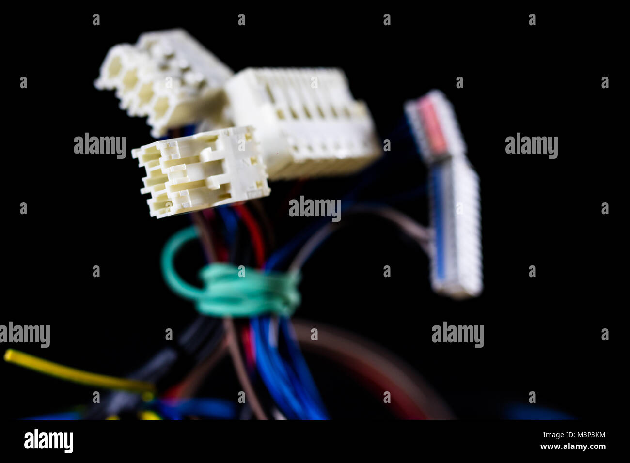 Electric cables, plugs and connectors on a wooden workshop table ...