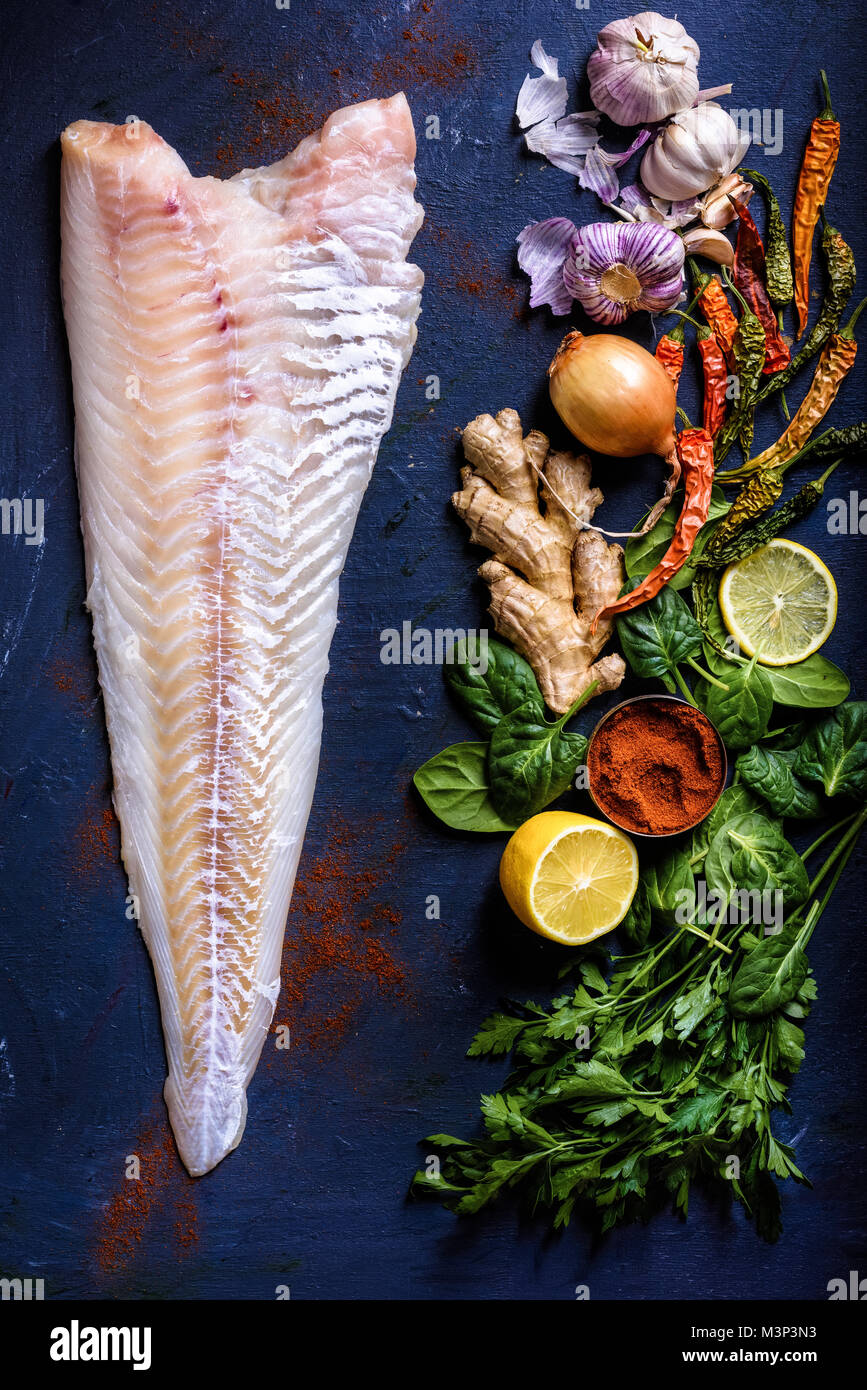 top view of raw fish fillet with ingredients on blue Stock Photo - Alamy
