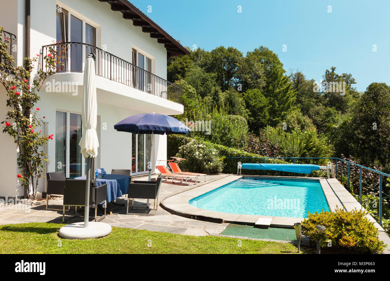 Nice terrace with swimming pool in a house Stock Photo - Alamy