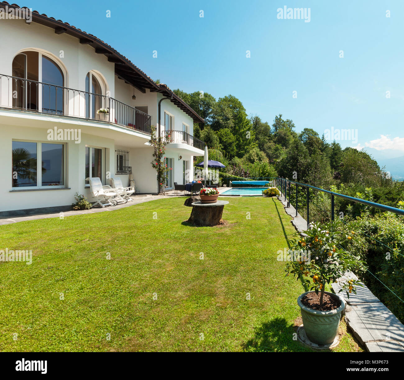 Nice terrace with swimming pool in a house, garden Stock Photo - Alamy