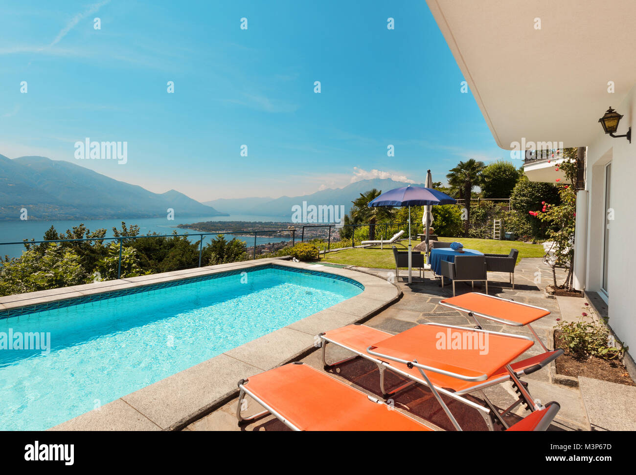 Nice terrace with swimming pool in a villa on the lake Stock Photo - Alamy