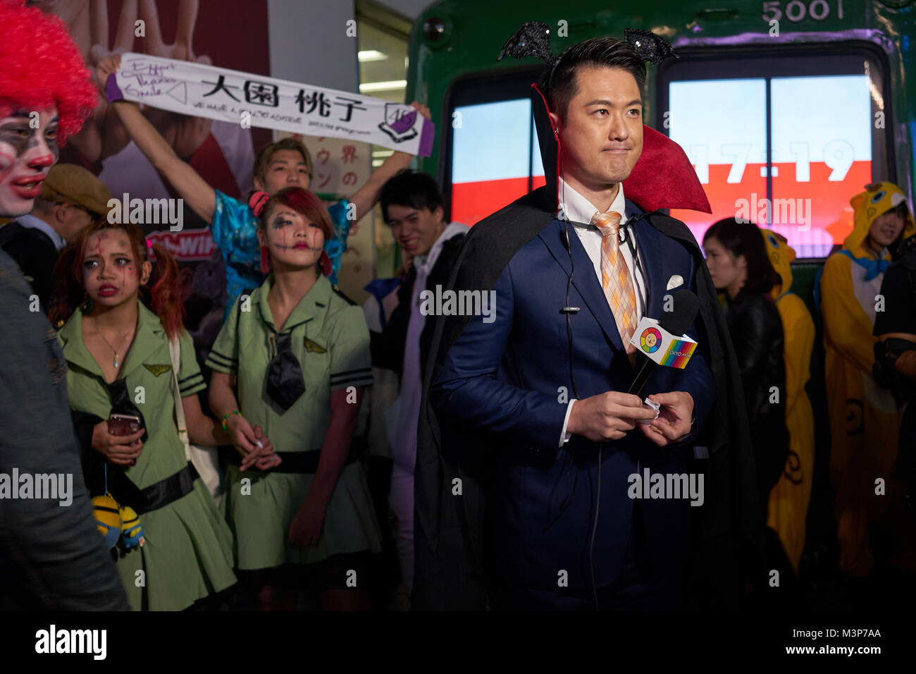 Japanese TV presenter covering the Halloween celebrations in Shibuya ...