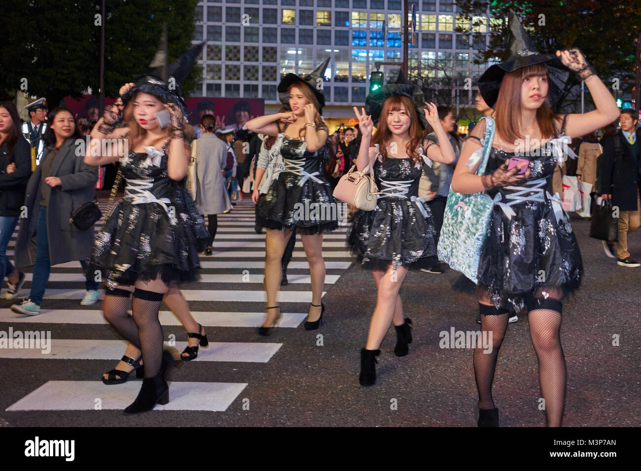 A group of young Japanese girls on the Shibuya Crossing, Tokyo, dressed ...