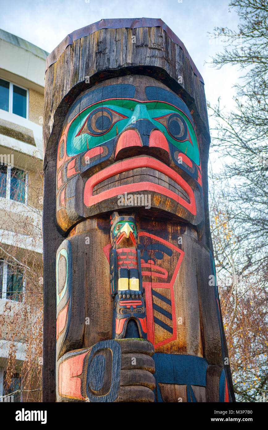 View of ancient colorful Totem Pole with blue sky behind it in Duncan ...