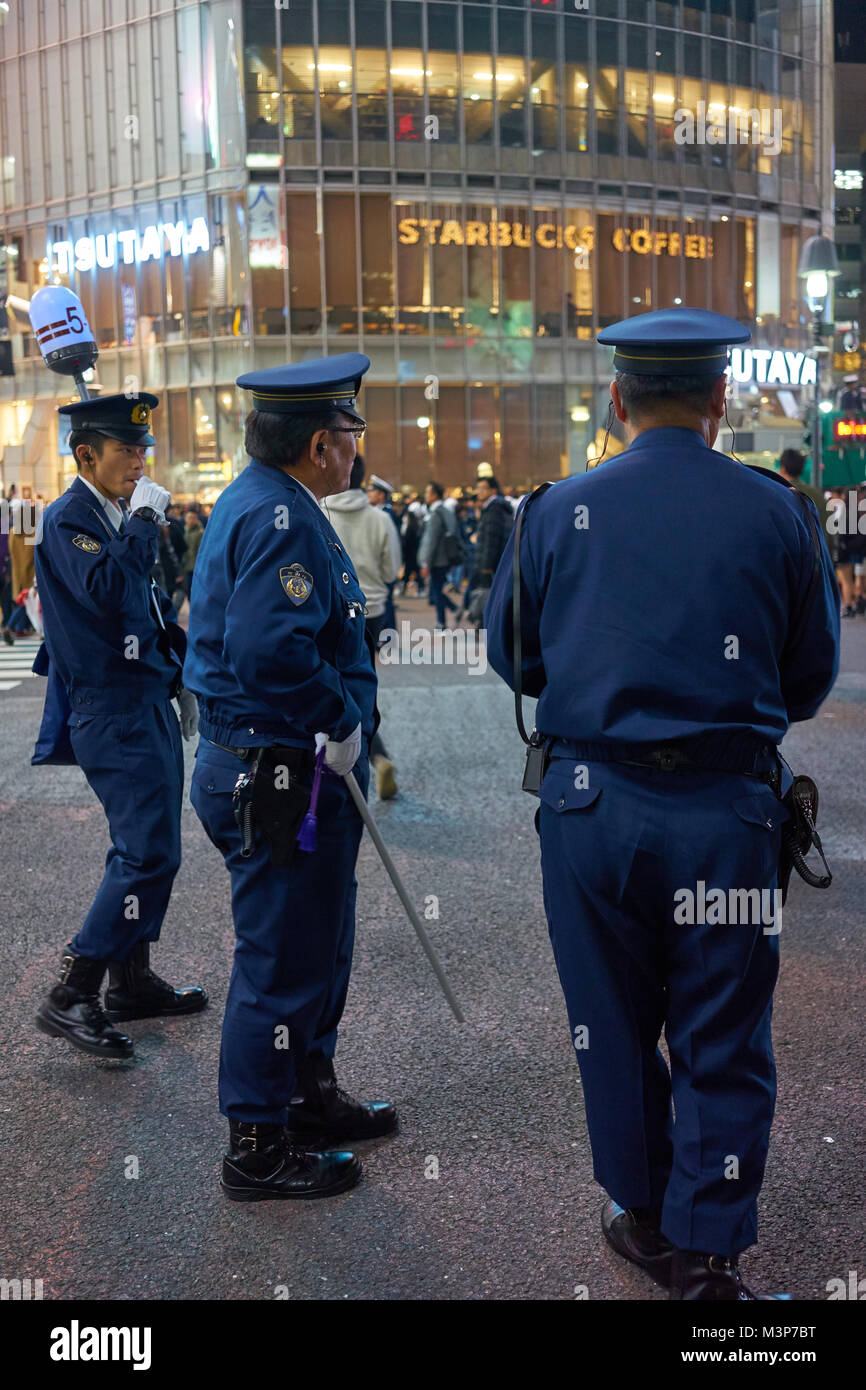 Japanese policemen controlling the crowds of people during the ...