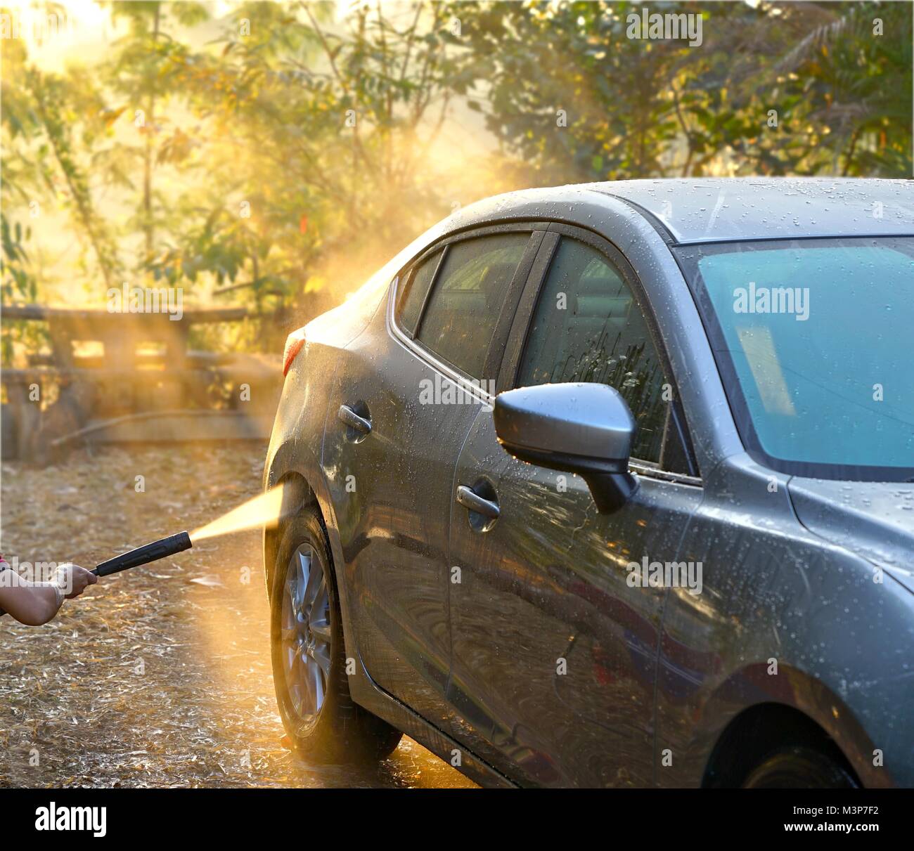 Car Washing. Cleaning grey color car using high pressure water in the ...