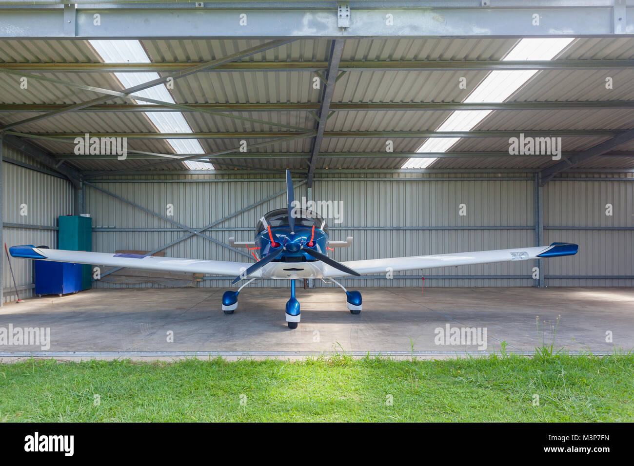 Aircraft two seater plane inside hangar garage in remote countryside ...