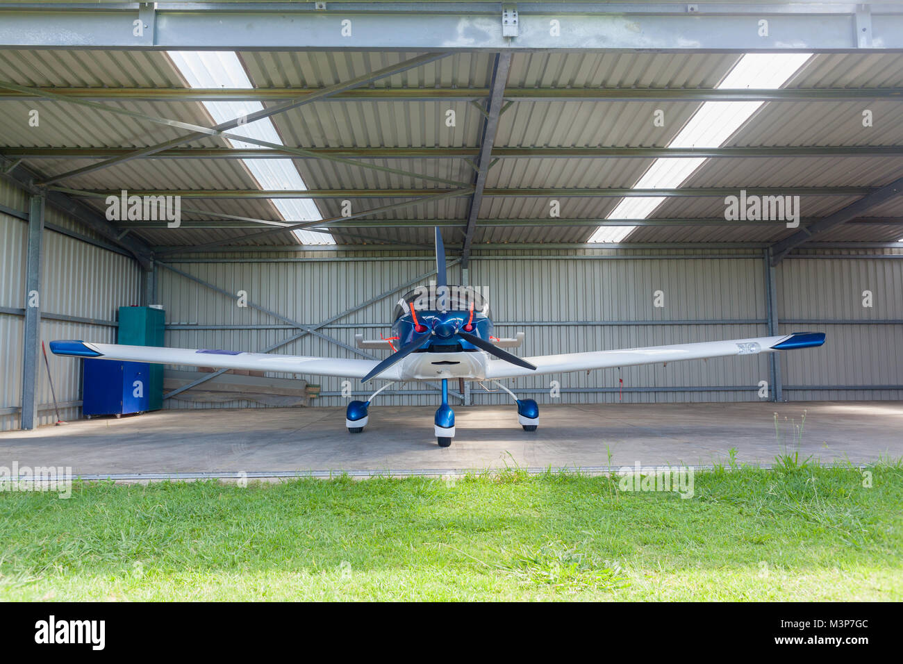 Aircraft two seater plane inside hangar garage in remote countryside ...