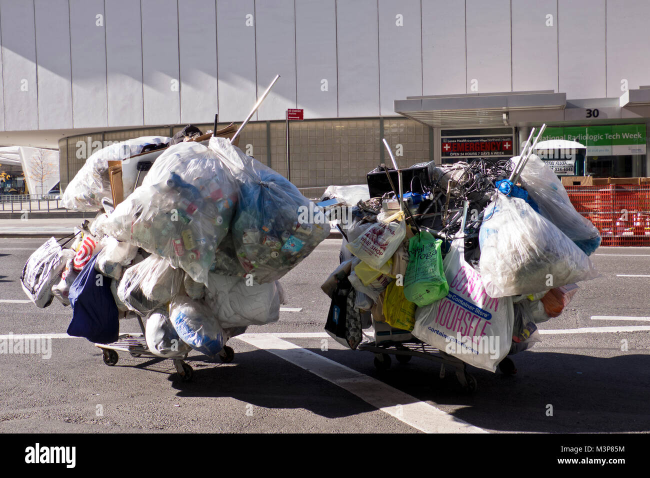 Homeless person's shopping trolley carts piled with all their ...