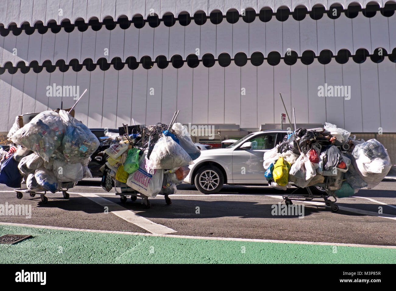 Homeless person's shopping trolley carts piled with all their ...