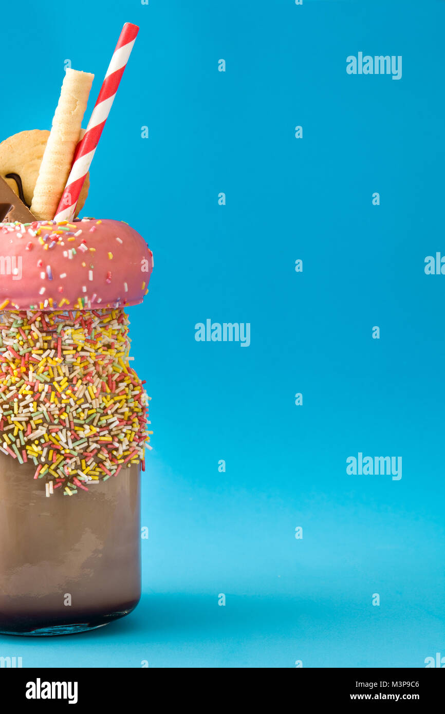 Extreme milkshake or freak shake on blue background. Copyspace Stock ...
