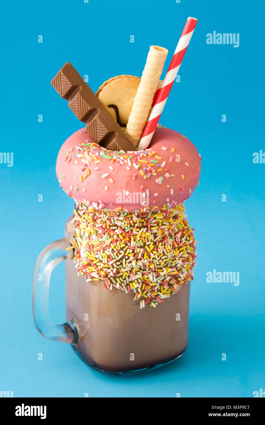 Extreme milkshake or freak shake on blue background. Copyspace Stock ...