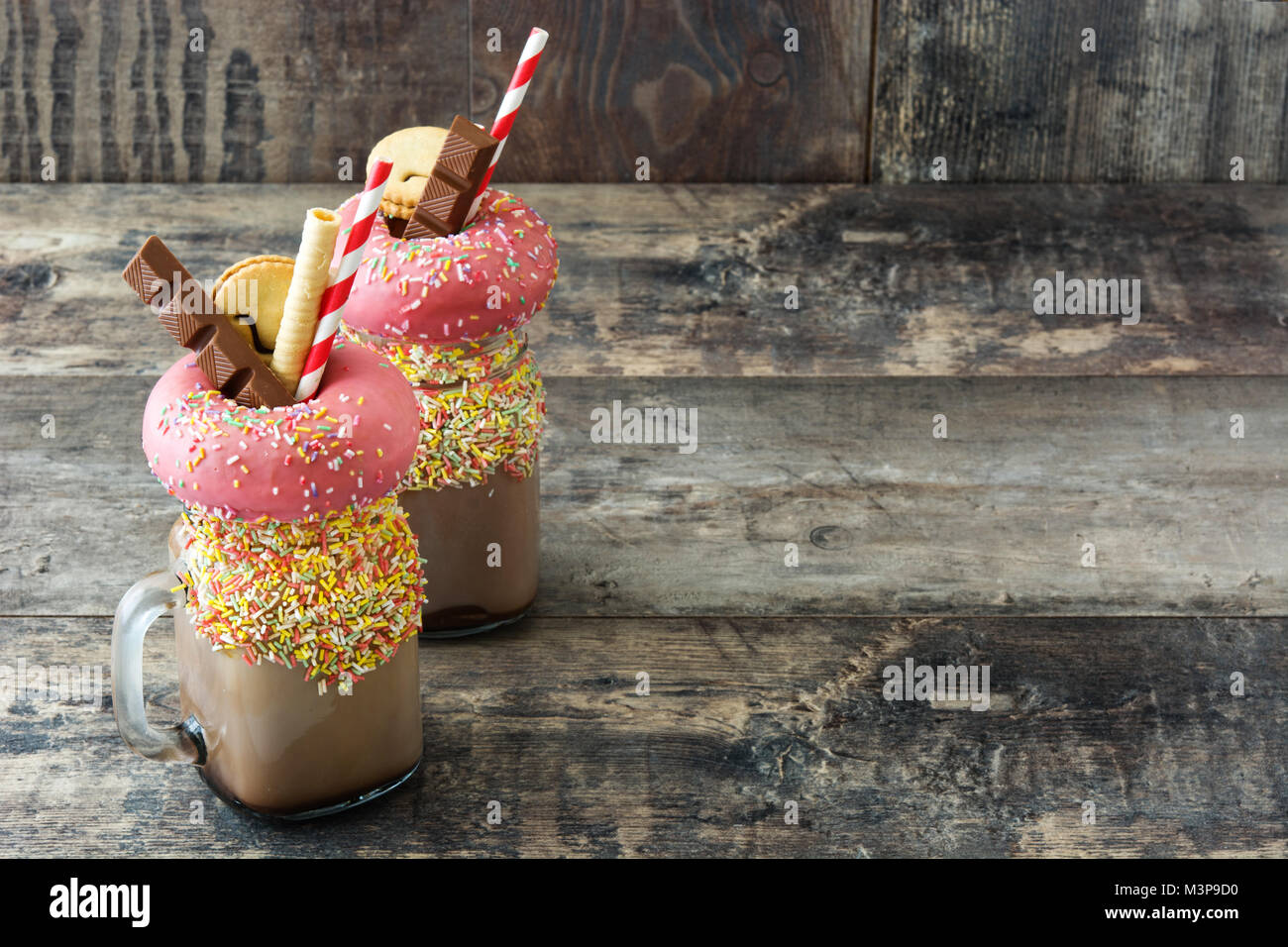 Extreme milkshake or freak shake on wooden table Stock Photo - Alamy