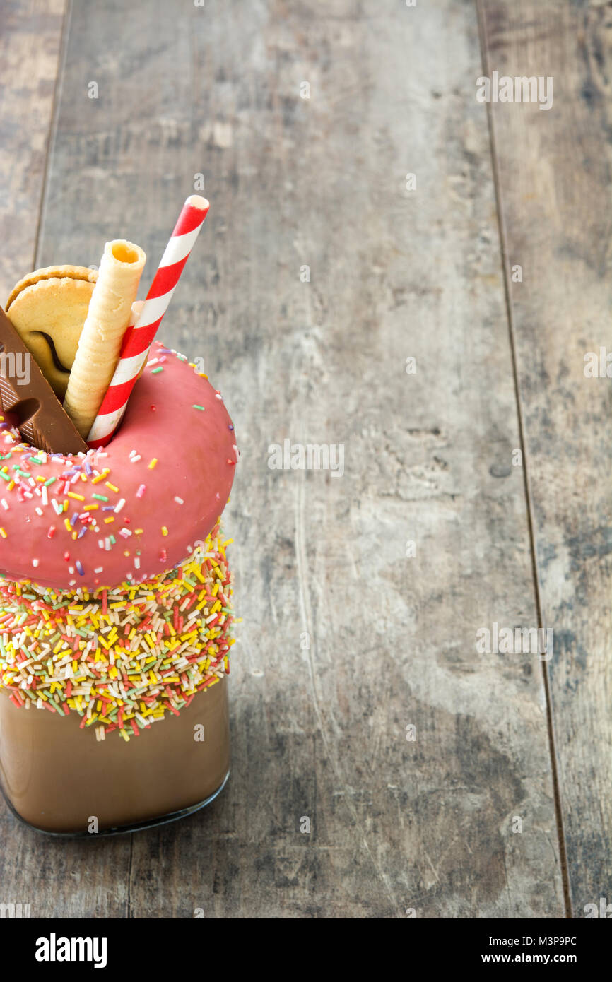 Extreme milkshake or freak shake on wooden table Stock Photo - Alamy