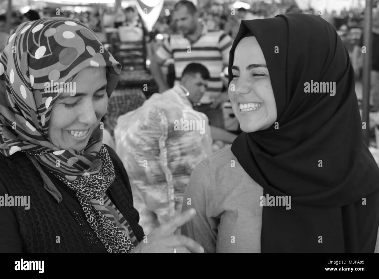 A portrait of a young turkish girl and her mother working at a fresh ...