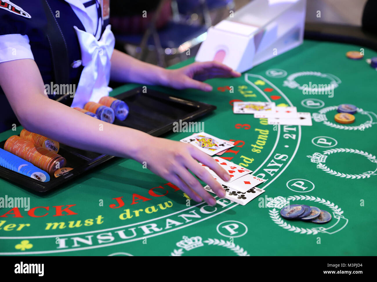 Chiba, Japan. 10th Feb, 2018. A female dealer plays a card game ...