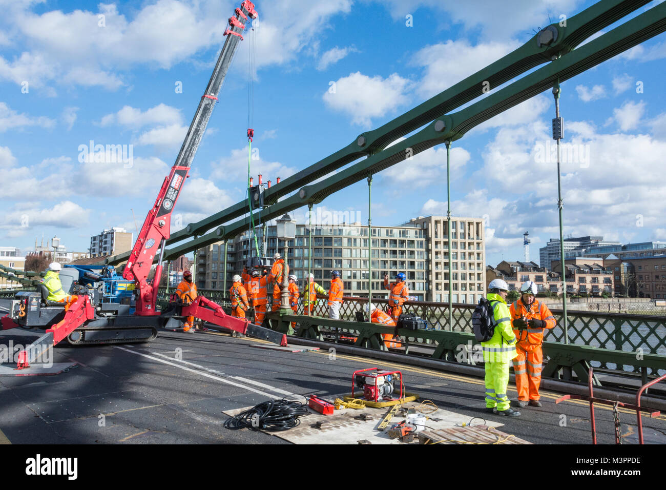 Workmen undertaking repair and maintenance work on Hammersmith Bridge ...