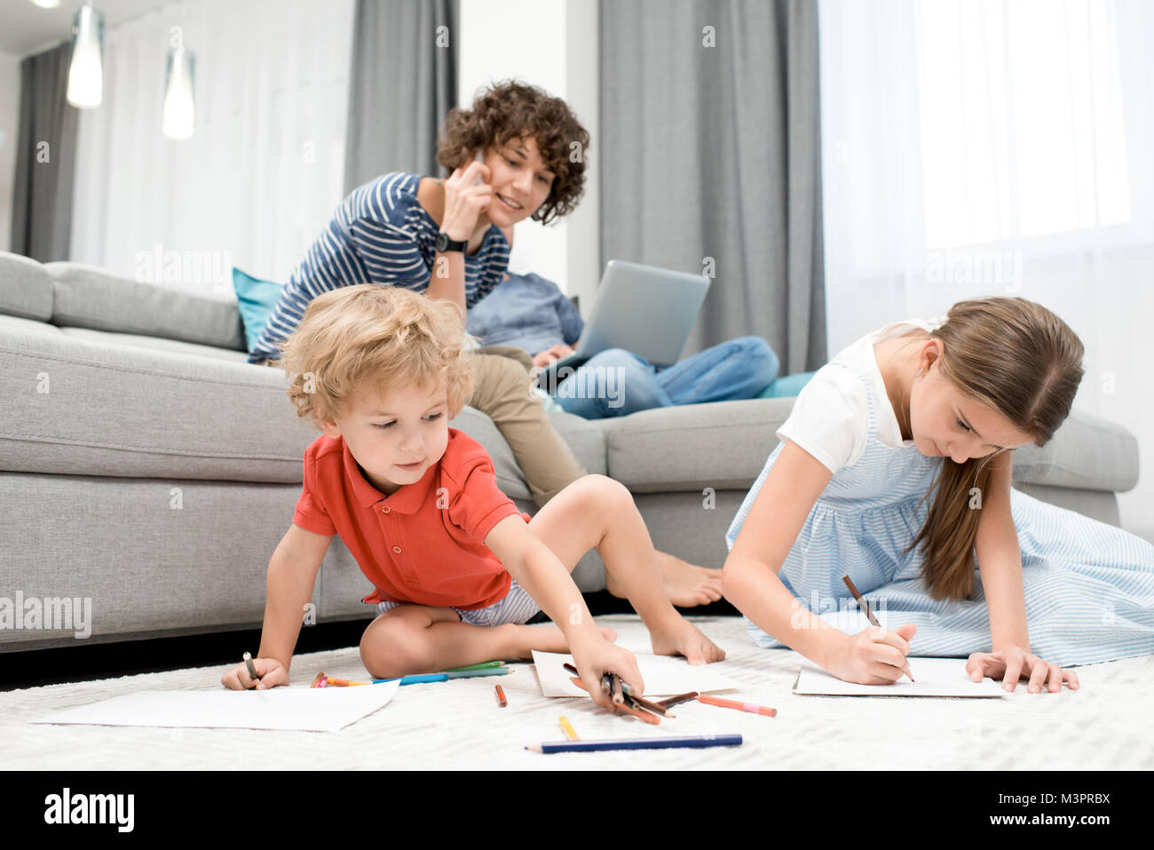 Mother Watching Kids at Home Stock Photo - Alamy