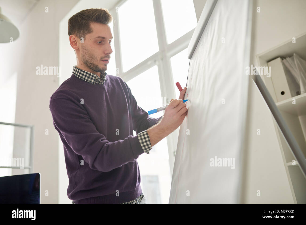 Young Man Writing on Whiteboard Stock Photo - Alamy