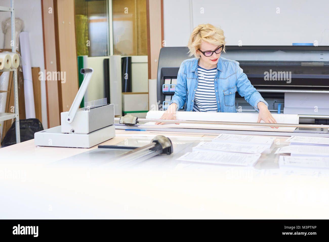 Young Woman Working in Printshop Stock Photo - Alamy