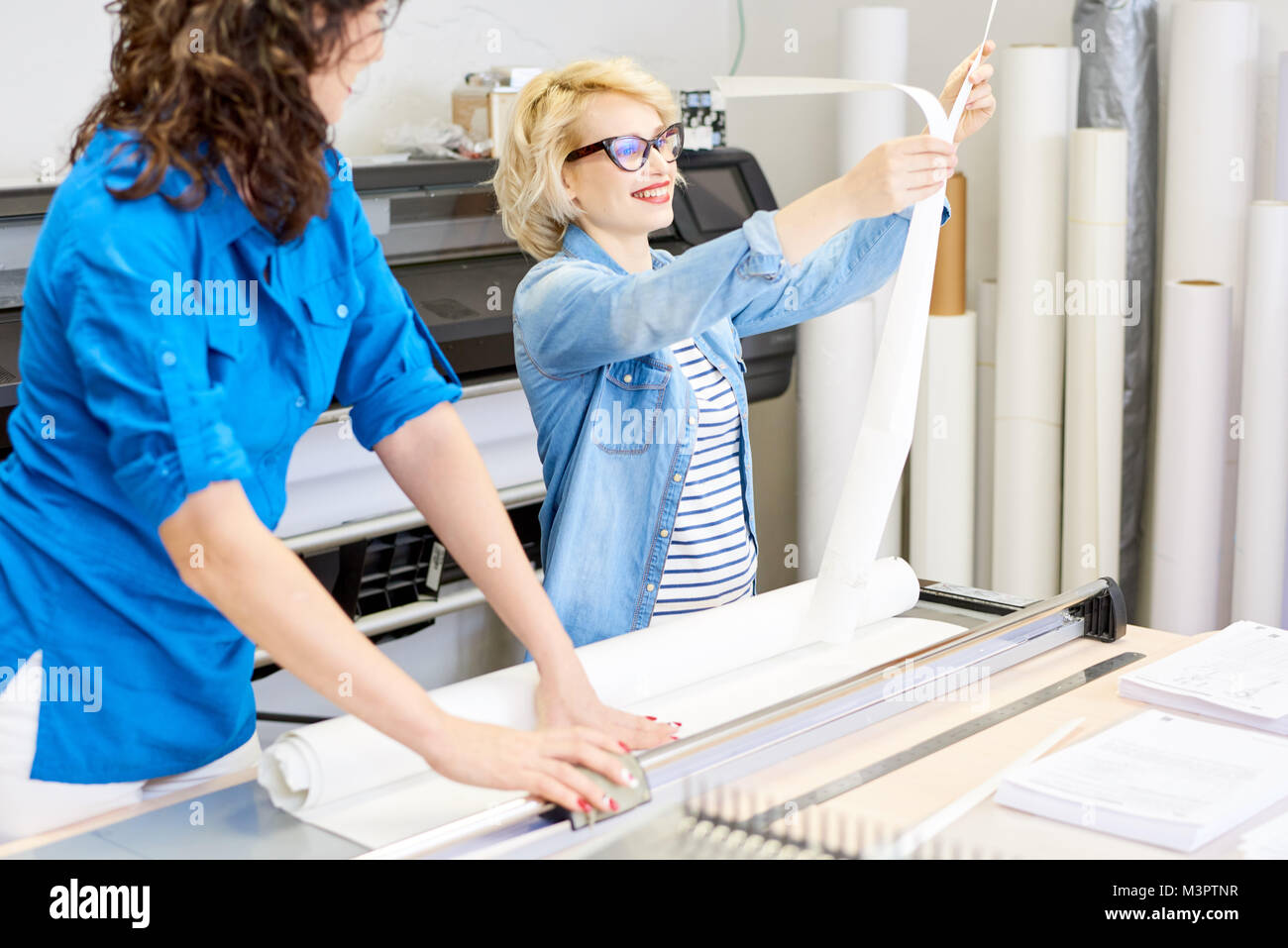 Two Women Working in Printshop Stock Photo - Alamy