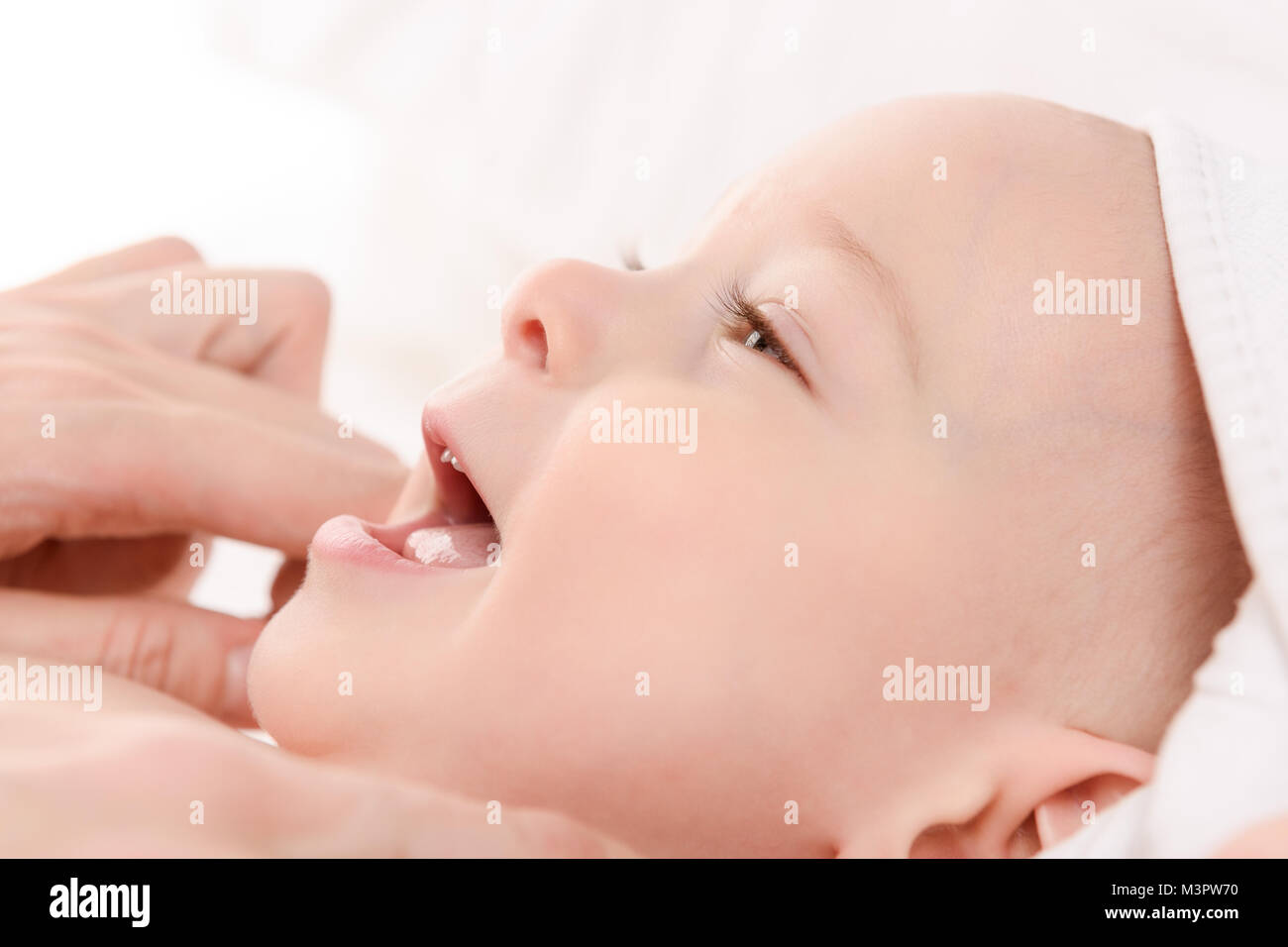 Newborn Baby Touching His Face High Resolution Stock Photography and ...