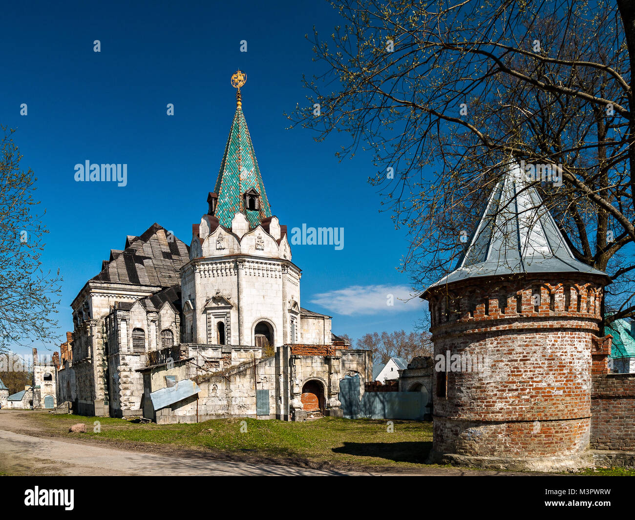 The main building is white and a small tower of red brick ruin ...