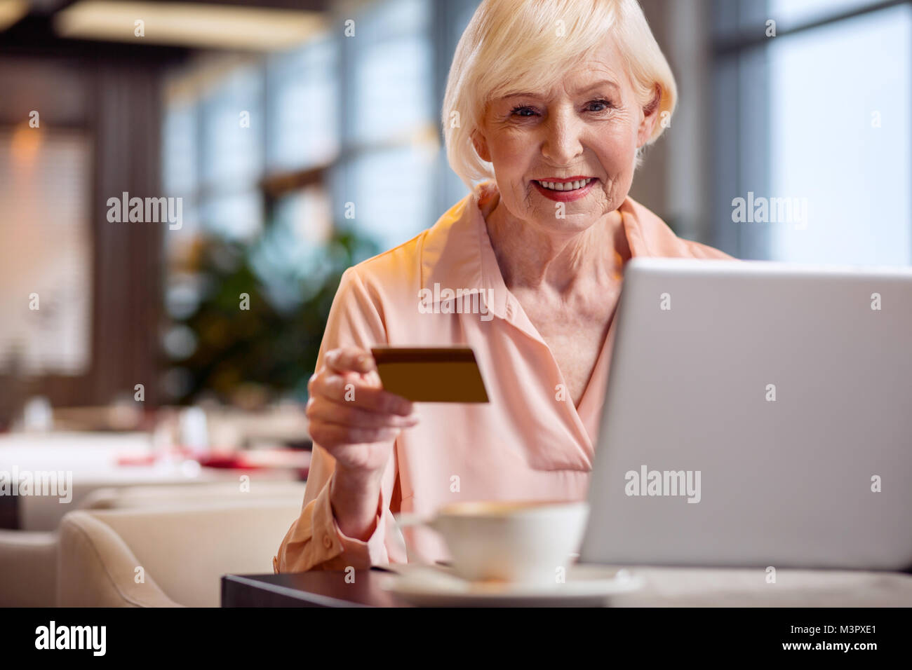 Positive mature woman using credit card Stock Photo - Alamy Positive mature woman using credit card Stock Photo - Alamy
