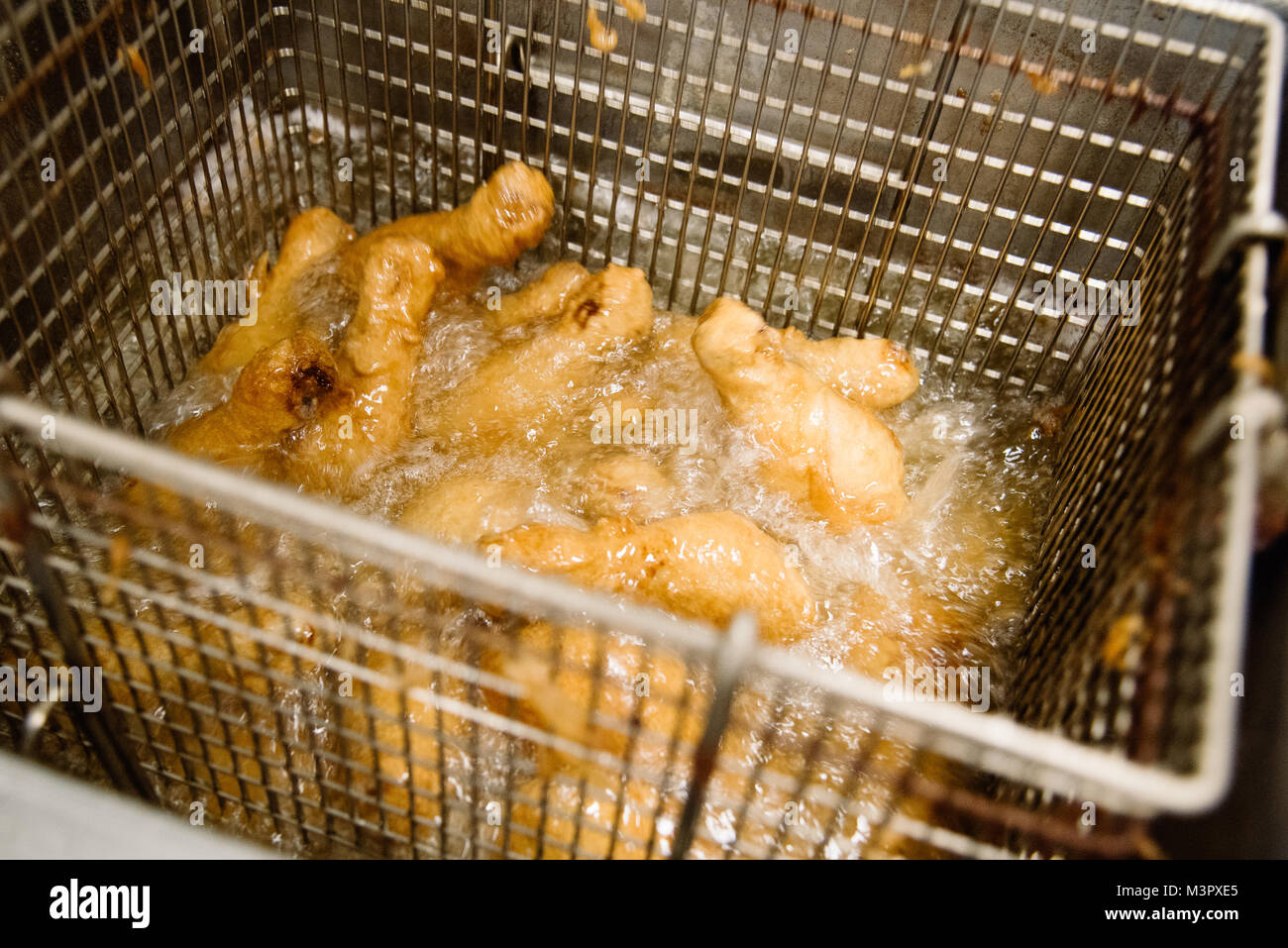 Process of making fried chicken on the kitchen. Restaurant or pizzeria ...
