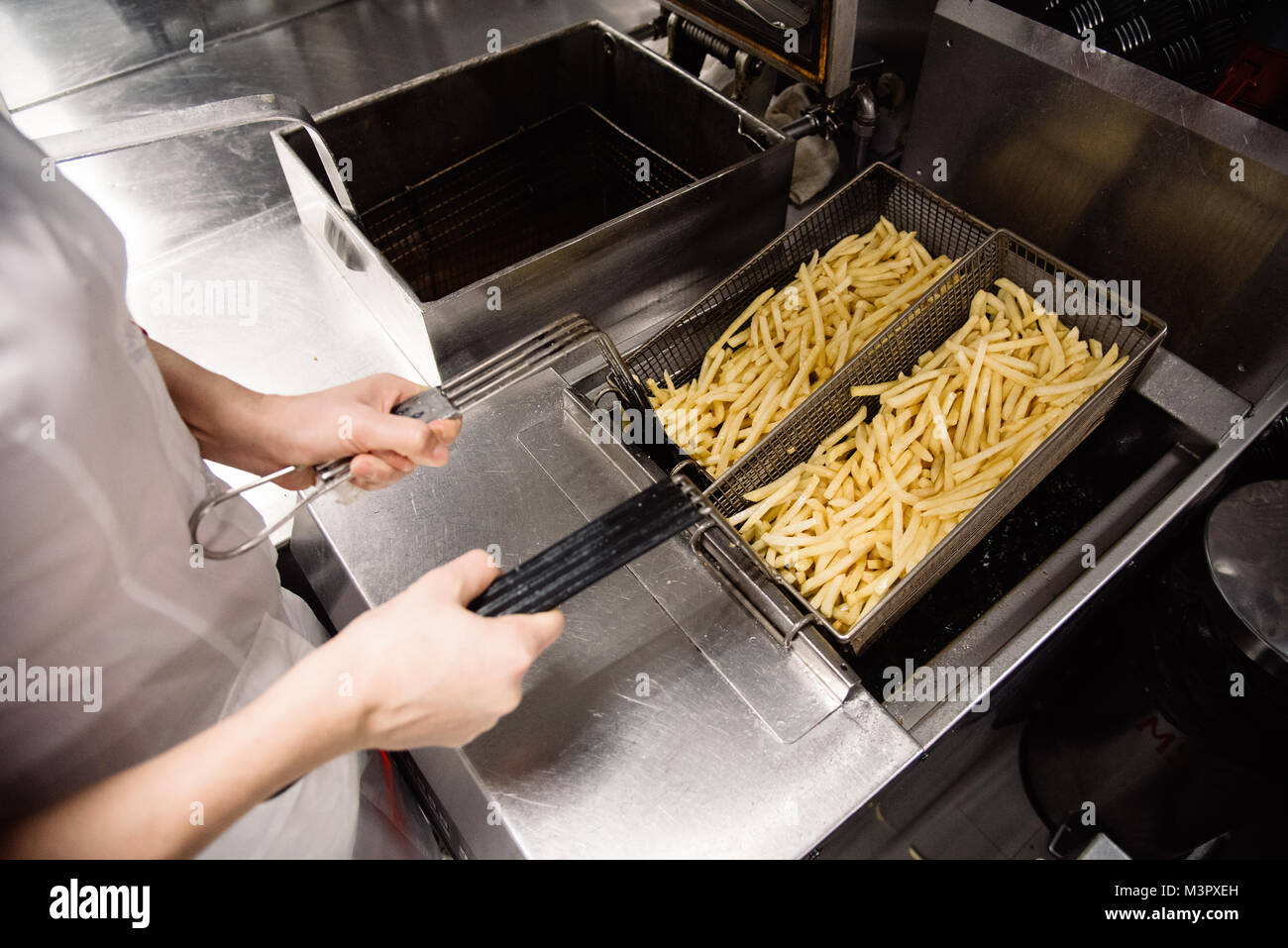 Process of making fried potato on the kitchen. Restaurant or cafe ...