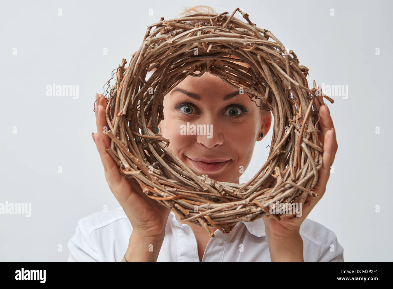 Smiling girl with a wreath of twigs Stock Photo - Alamy