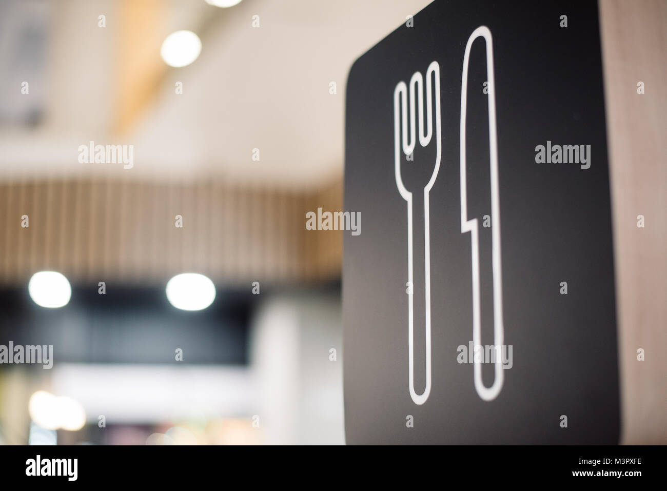 Fork and knife sign in interior of restaurant or cafe, black and white ...