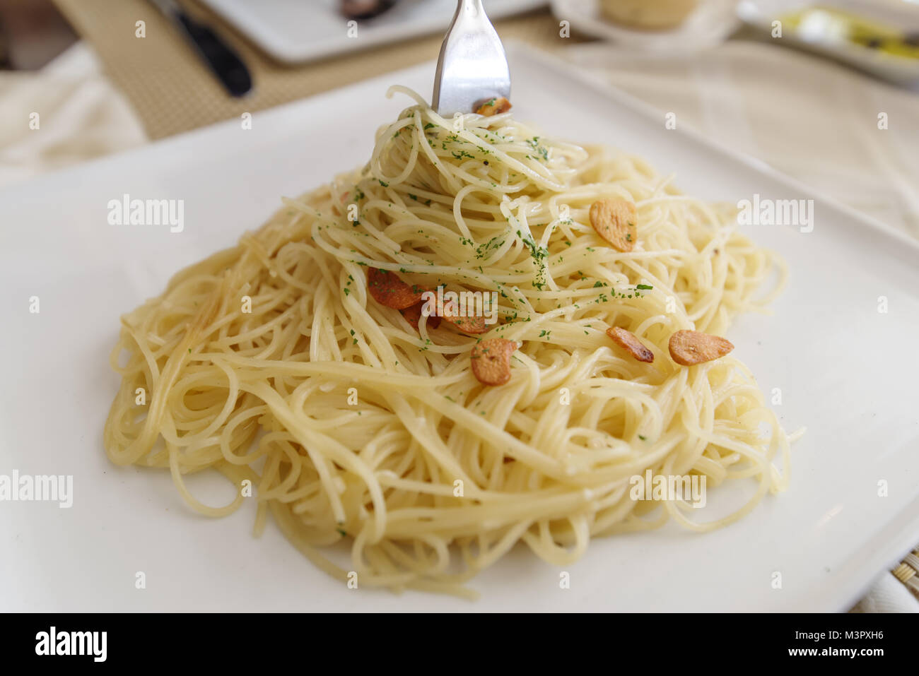 oil base pasta Spaghetti Aglio on the table, Manila Stock Photo - Alamy