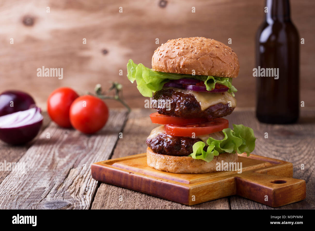 Delicious homemade two patty burger with lettuce, cheese. tomato, red ...