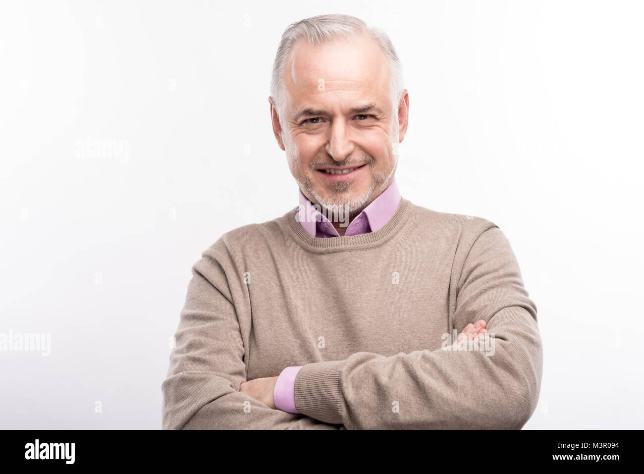 Handsome senior man folding hands across his chest Stock Photo - Alamy