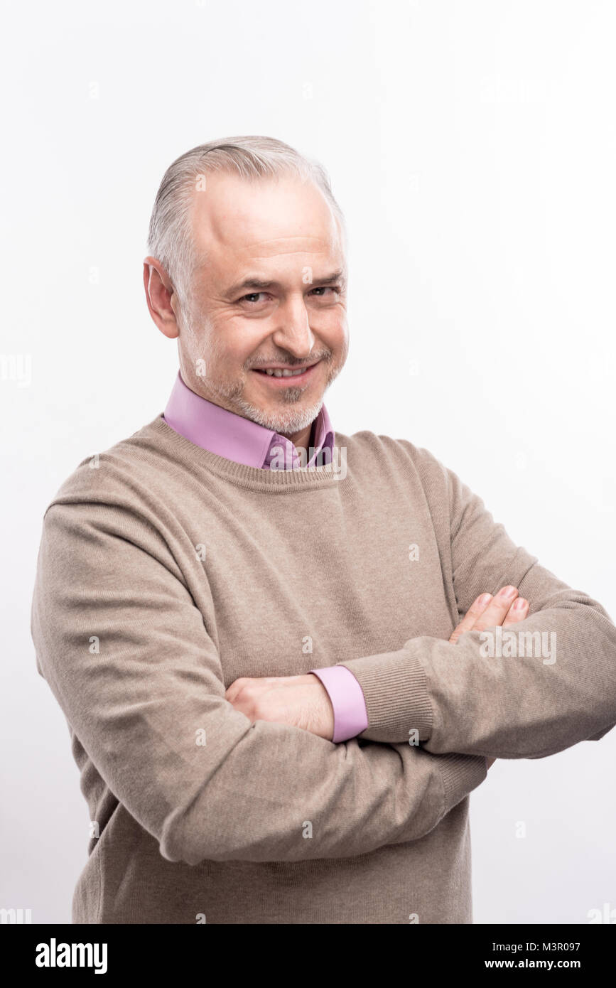 Charming senior man posing with his hands folded across chest Stock ...