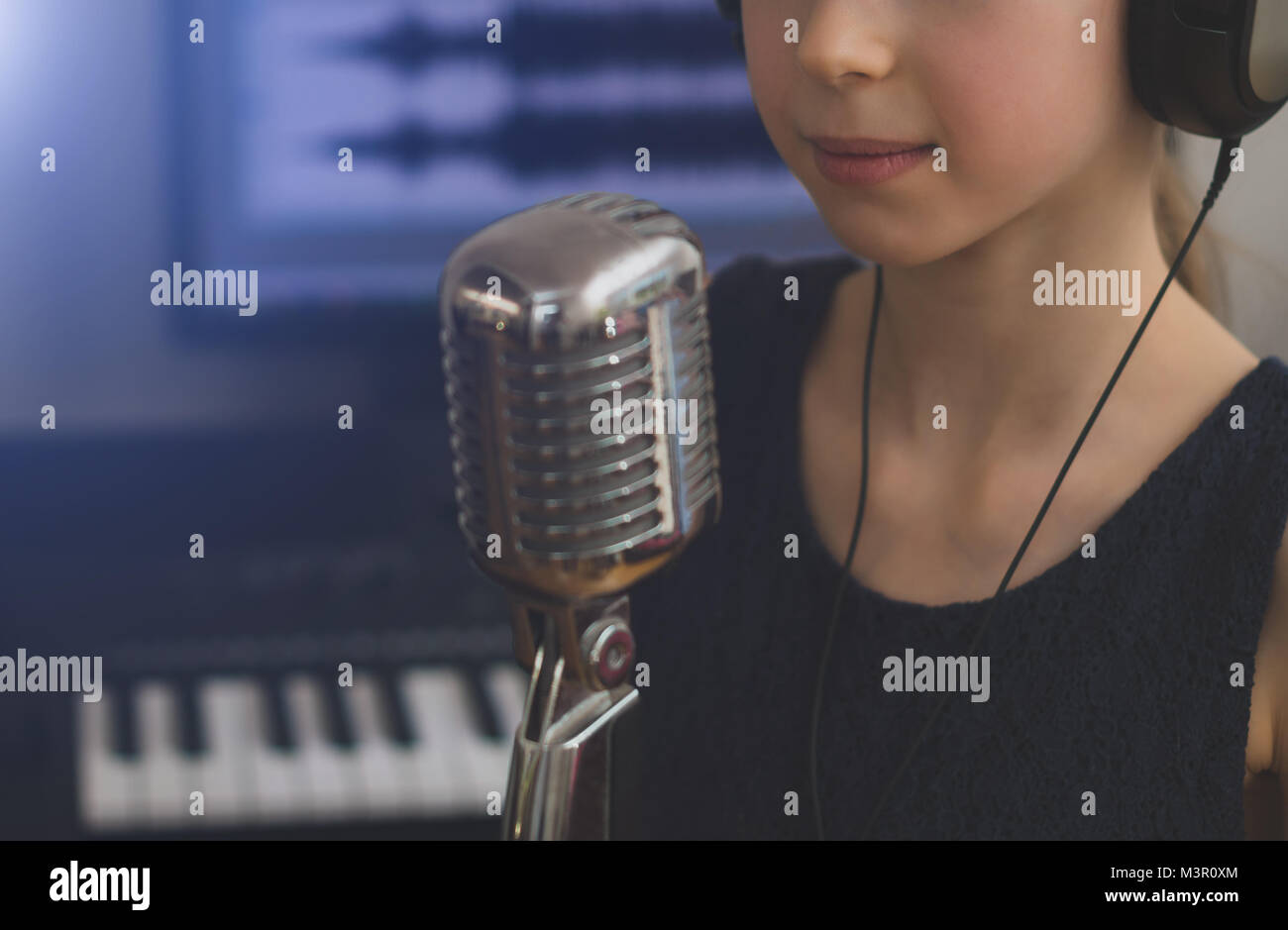 Little girl singing a song in home recording studio Stock Photo - Alamy