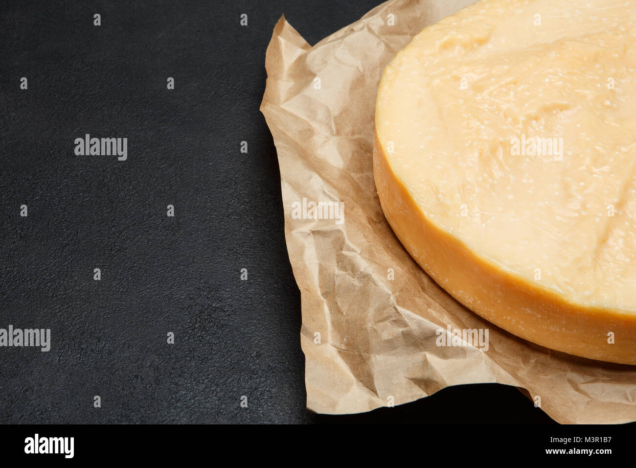 Whole round Head of parmesan or parmigiano hard cheese on concrete ...