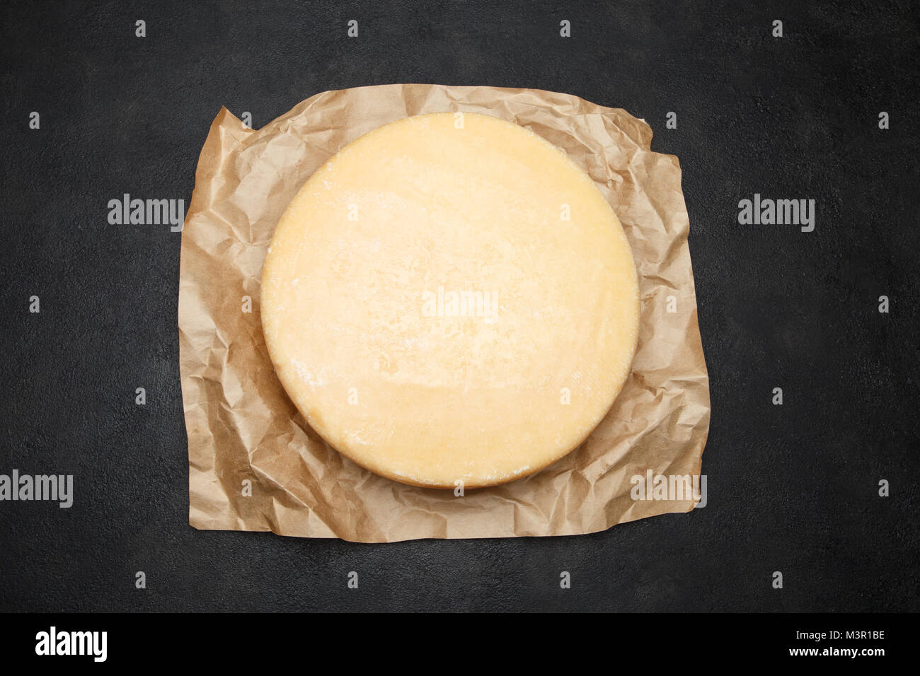 Whole round Head of parmesan or parmigiano hard cheese on concrete ...