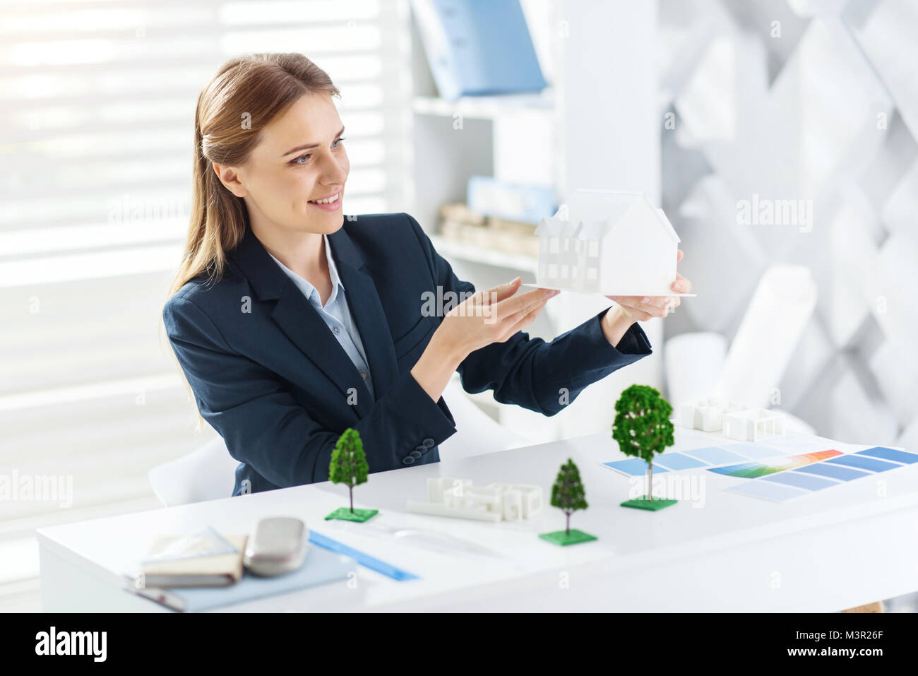 Good engineer examining the model of the house Stock Photo - Alamy